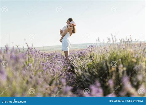 Happy Mom Holds Her Daughter In Her Arms Smiles And Rejoices Stock