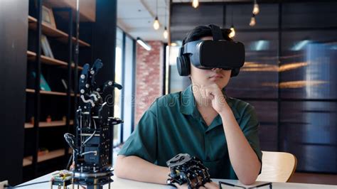 Asian Boy Wearing A 3d Ride Around His Eyes On Head And Have Headphones Attached Player Listen