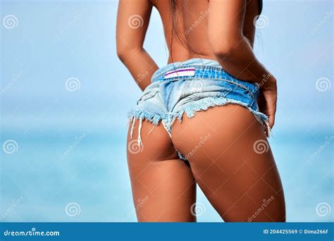 Girl In The Blue Shorts Posing At The Tropical Beach Stock Image