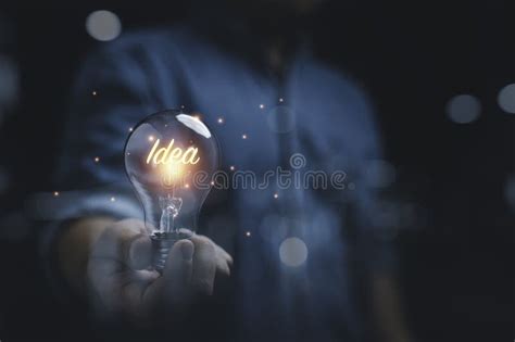 Businessman Holding Glowing Idea Inside Lightbulb For Creative Thinking Idea And Problem Solving
