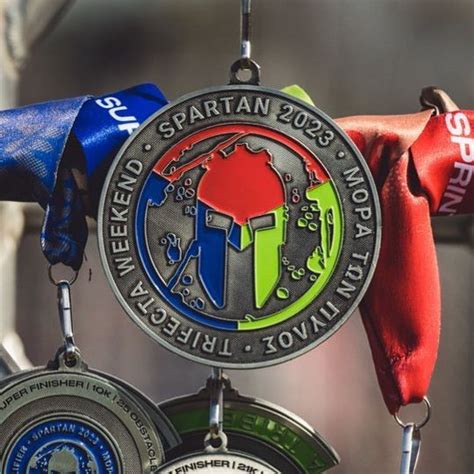 Three Medals Are Hanging From The Side Of A Bike