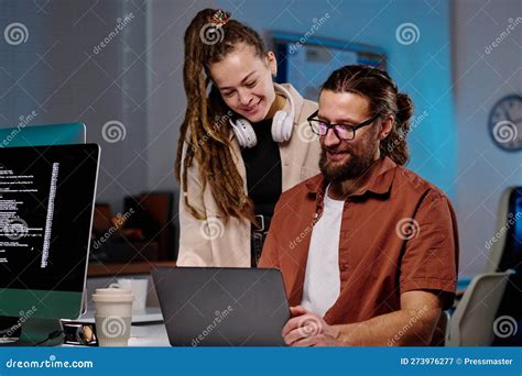Two Happy Young Programmers Looking At Laptop Screen With Coded Data Stock Image Image Of Code