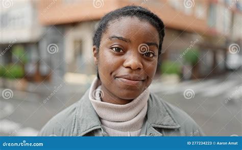 African American Woman Standing With Relaxed Expression At Street Stock
