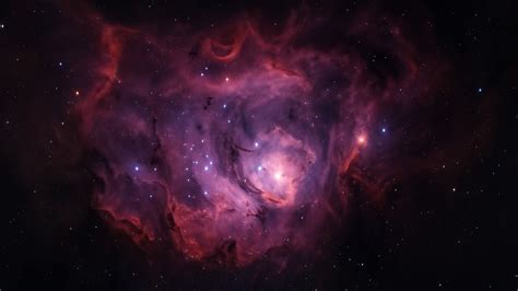 Glowing Purple And Red Nebula Filled With Stars Swirls In The Vast