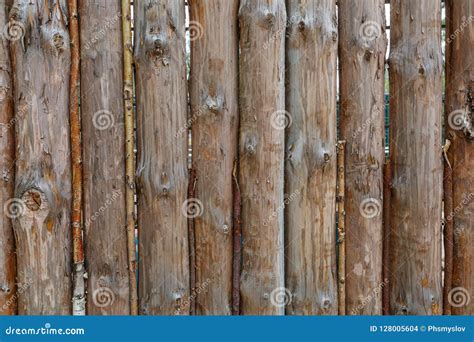 A Fence Made From Brown Round Vertical Pine Logs Natural Log