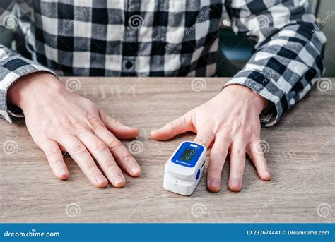 A Man Checking Oxygen Level At Home With Home Oximeter Patient Measuring The Blood Oxygen With