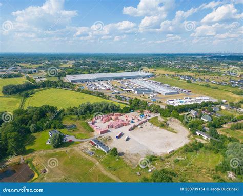aerial view of storage and freight terminal with trucks and containers