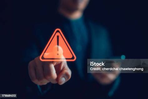 Hand Showing Red Triangle Caution Warning Sign For Maintenance Notification Error And Risk