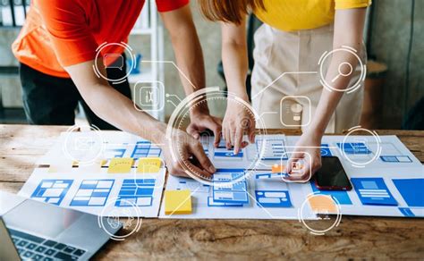 Ux Developer And Ui Designer Brainstorming About Mobile App Interface Wireframe Design With