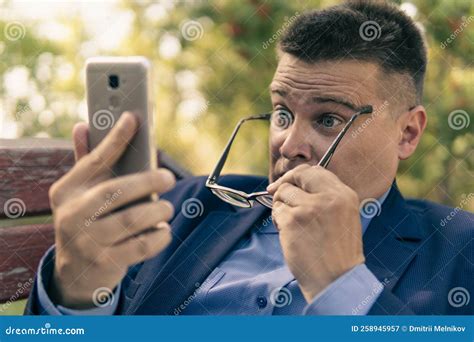 Shocking Message Worried Senior Man Reading Text Message On Phone Outside In The Green Park