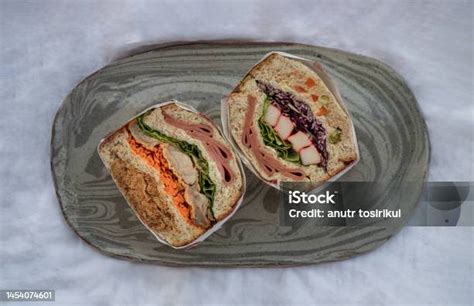 햄 치즈 게 스틱 돼지 고기 마요네즈 말린 갈가리 찢긴 돼지 고기 보라색 양배추 및 혼합 야채로 채워진 수제 샌드위치 갈색 빵에