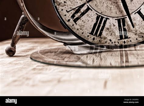 Broken Old Analog Clock With Glass And Metal Frame On Wooden Table