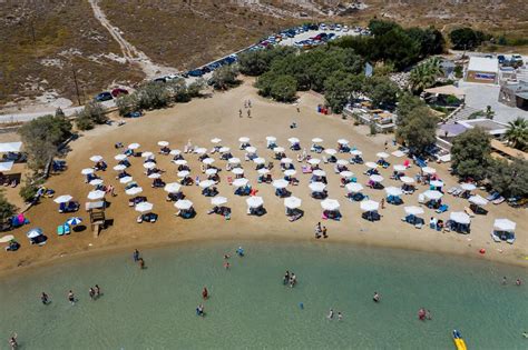 Aerial view of the Monastiri beach, with sunbeds and parasols on Paros ...