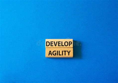 Develop Agility Symbol Concept Word Develop Agility On Wooden Blocks Beautiful Blue Background