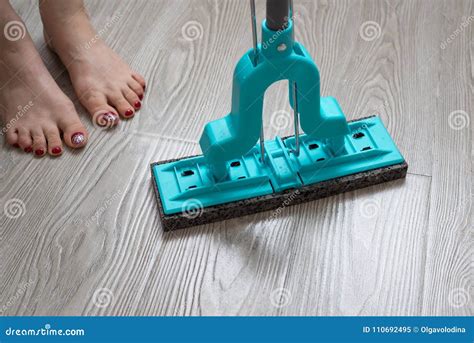 Female Feet And Blue Mop On Laminate Background Stock Image Image Of