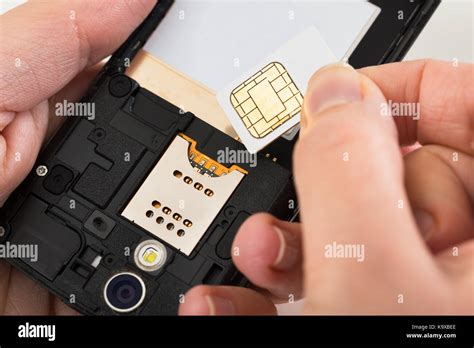 Close Up Of Person Hand Inserting A Sim Card Into Mobile Phone Stock Photo Alamy