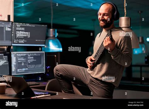 App Developer Singing And Playing Guitar With Keyboard Using It Equipment And Fooling Around