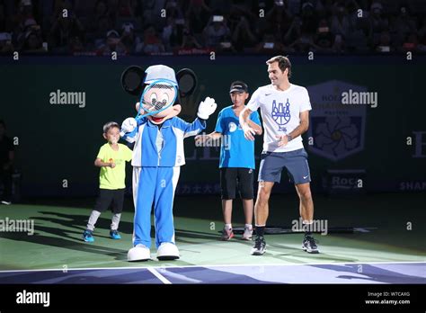 Swiss Tennis Player Roger Federer Enjoys A Dance Off With Mickey Mouse During Famiy Day Of