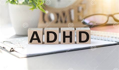 Adhd Text On Wooden Cubes Standing In A Row On Office Papers Stock