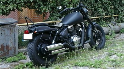 Custom Black Motorcycle Parked On Grass