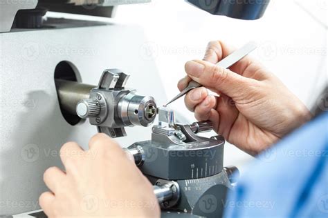 Closeup Of A Female Scientist Placing A Sample On A Transmission Electron Microscopy Grid