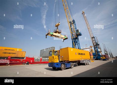 Dock Crane Loading And Unloading A Container From A Container Ship Stock Photo Alamy