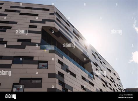A Modern Building With Geometric Patterns Highlighted By Sunlight The