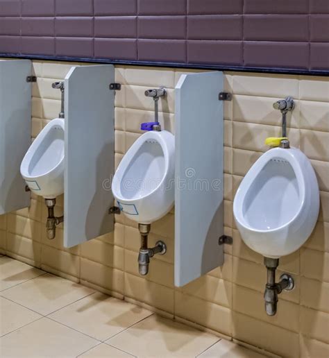 White Ceramic Urinals For Men In Public Toilet Room Stock Photo Image