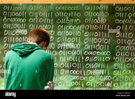 A Young Man Observes A Display Of Binary Code On A Window Representing Artwork Inside The