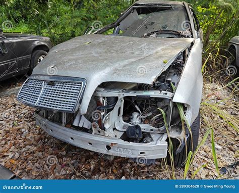 Unrecognizable And Wrecked Cars Beyond Repair Left At The Isolated Junk