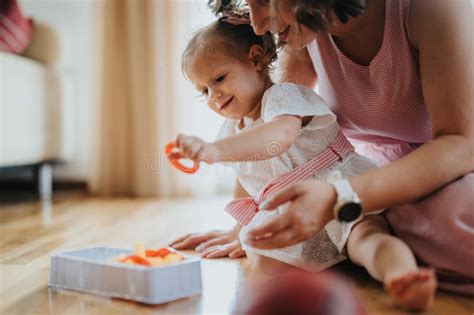 Mother And Daughter Bonding While Playing Together At Home Stock Image