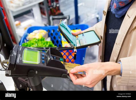 Woman Paying At The Checkout Counter Stock Photo Alamy