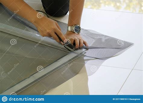 Man Install Mosquito Net Wire Screen On House Window Protection Against Insect Stock Photo