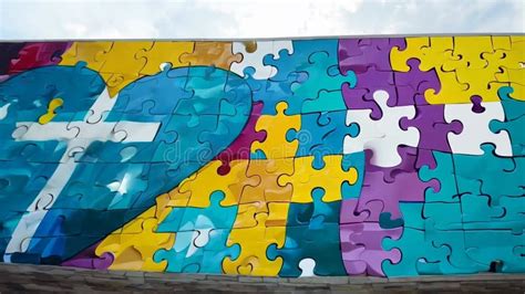 colorful urban mural of interconnected puzzle pieces forming a blue