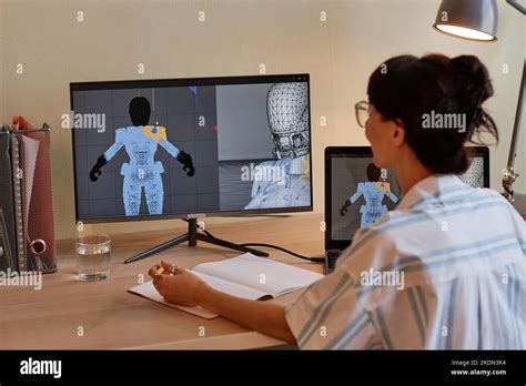 Back View At Young Female Designer Building Digital 3d Models And Using Computers At Workplace