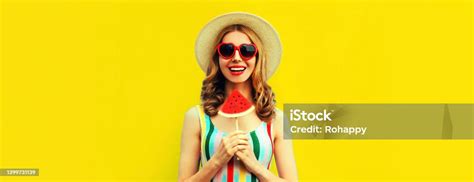 아이스크림 모양의 밀짚모자를 쓴 수박 조각 노란색 배경에 빨간 하트 모양의 선글라스 광고 텍스트를위한 빈 복사 공간을 가진 행복한 웃는 젊은 여성의 여름 초상화 25 29
