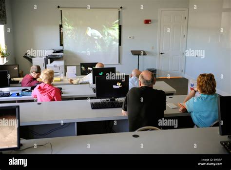 Adult Men And Women Using Technology In Computer Learning Center Stock Photo Alamy