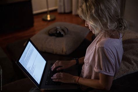Blonde Woman Typing On Her Laptop In The Evening By Stocksy Contributor Jovo Jovanovic Stocksy