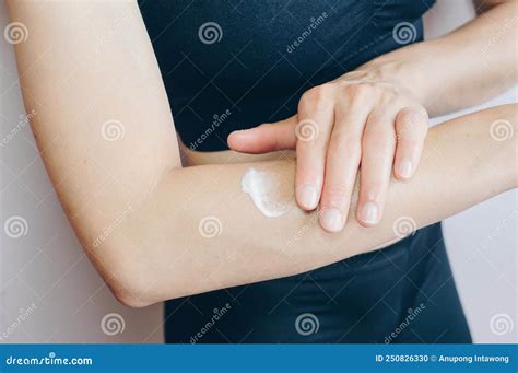 Close Up View Of Woman Applying Sunscreen Lotion On Her Body For