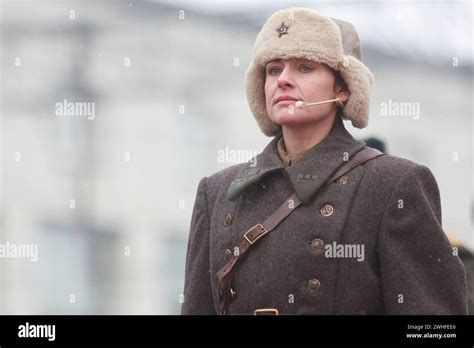 A Reenactor Wearing A Soviet Military Uniform Is Seen On A Platform During A Historical