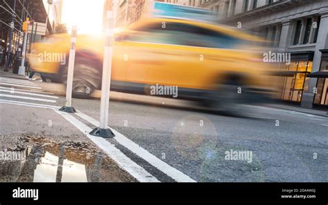 Nyc Yellow Taxi Cab Driving Down The Street In Manhattan New York City