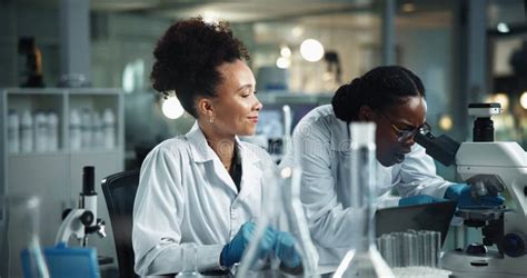 Women Microscope And Scientist Team Research In Lab For Experiment Analysis And Biotechnology