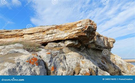 Overhanging Rocky Cliff With Blue Sky And White Clouds Stock Image 340574695