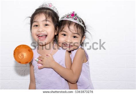 Female Asian Identical Twins Sitting On Stock Photo Shutterstock