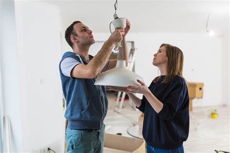 Premium Photo Couple Installing Lamp
