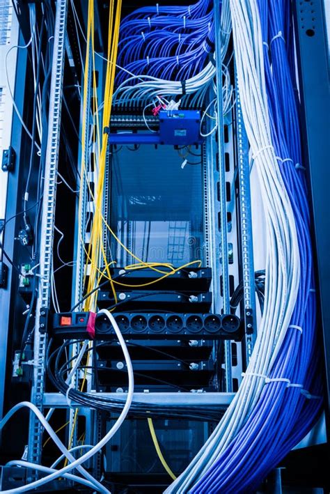 large group of utp cables ethernet cables in rack cabinet lead stock