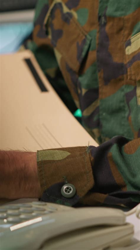 Vertical Military Soldier In Mission Control Center Answering Telephone Call Overseeing