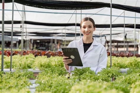 Agricultural Researchers Analyzing Horticultural Innovations In A