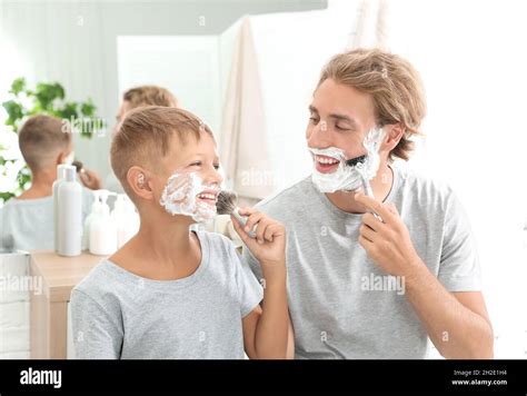 Father And Son Shaving Together In Bathroom Stock Photo Alamy