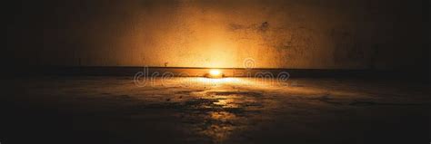 In A Dimly Lit Room A Small Light Source Gently Illuminates The Floor